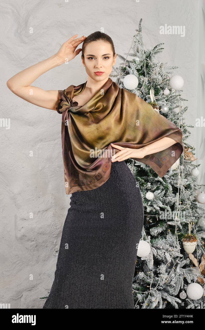 Beautiful and touchy young woman posing in silk scarf over the glitter ...