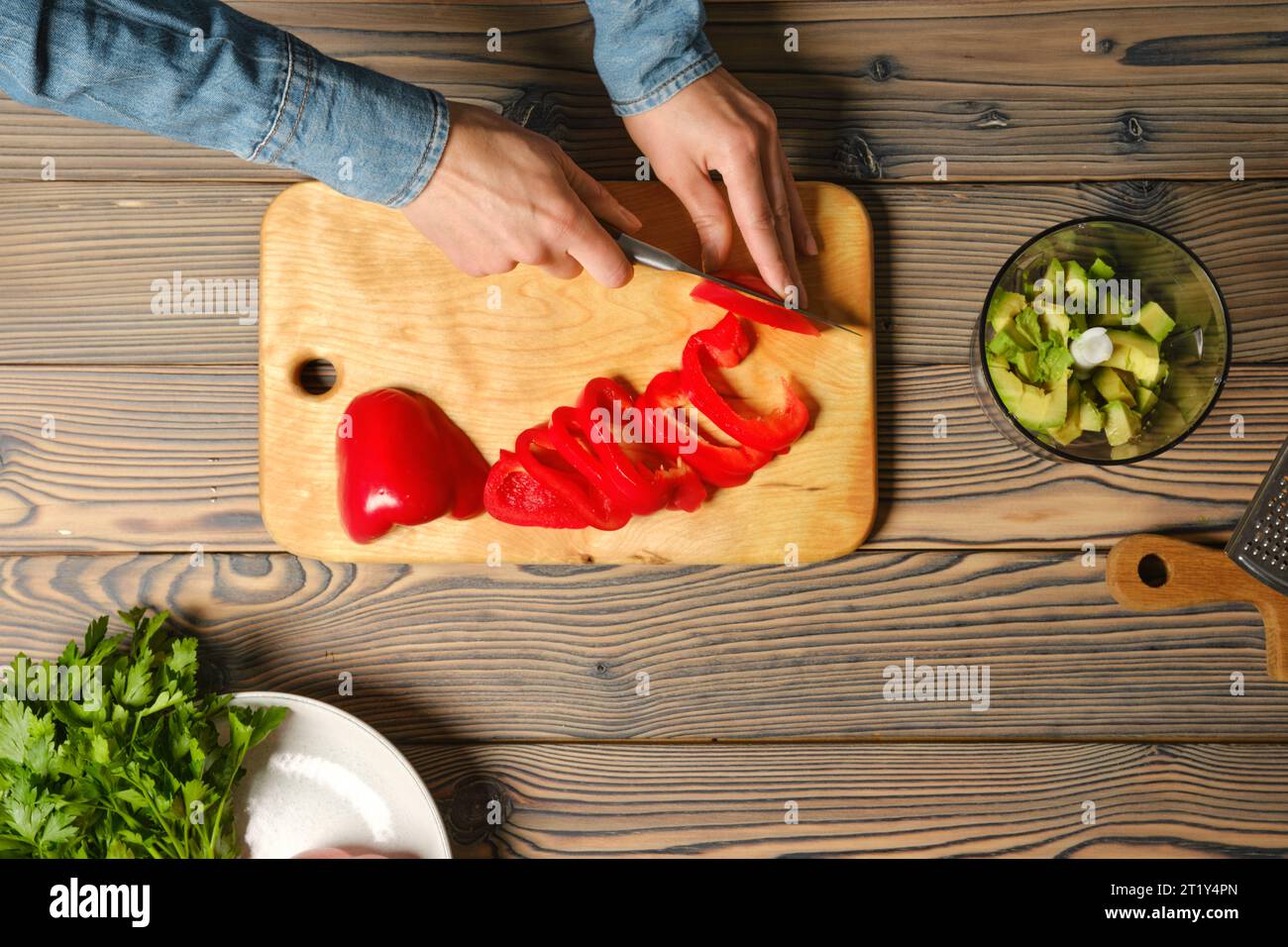 Top view of female hands slicing red bell pepper with kitchen knife ...