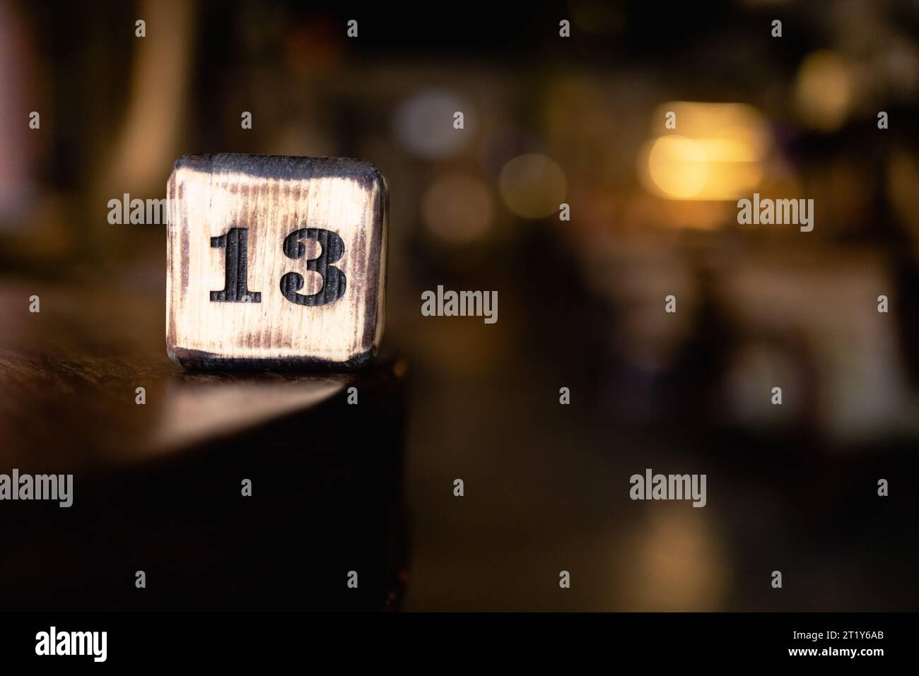 The number 13 on the wooden cube is burned with large symbols Stock ...