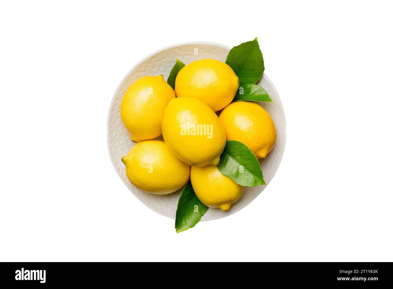 Fresh cutted lemon and whole lemons over round plate isolated on white ...