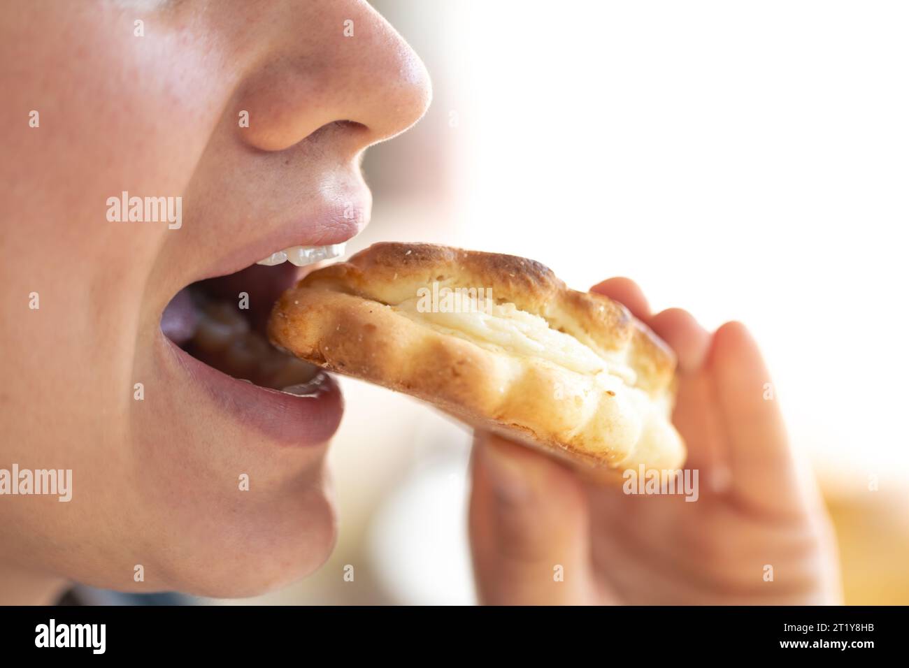 Woman biting bun close hi-res stock photography and images - Alamy