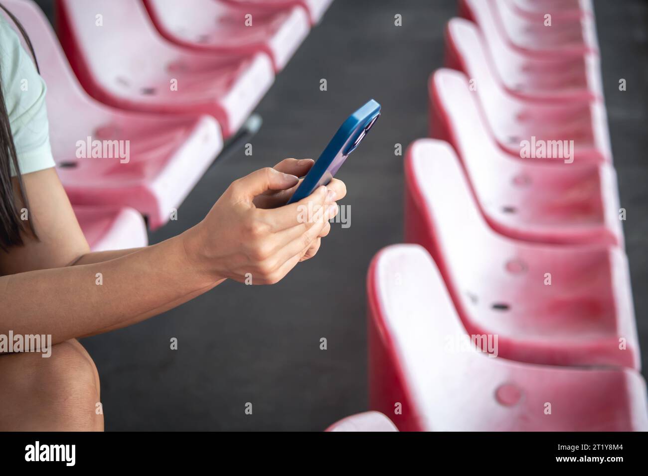 Woman uses mobile phone stadium hi-res stock photography and images - Alamy