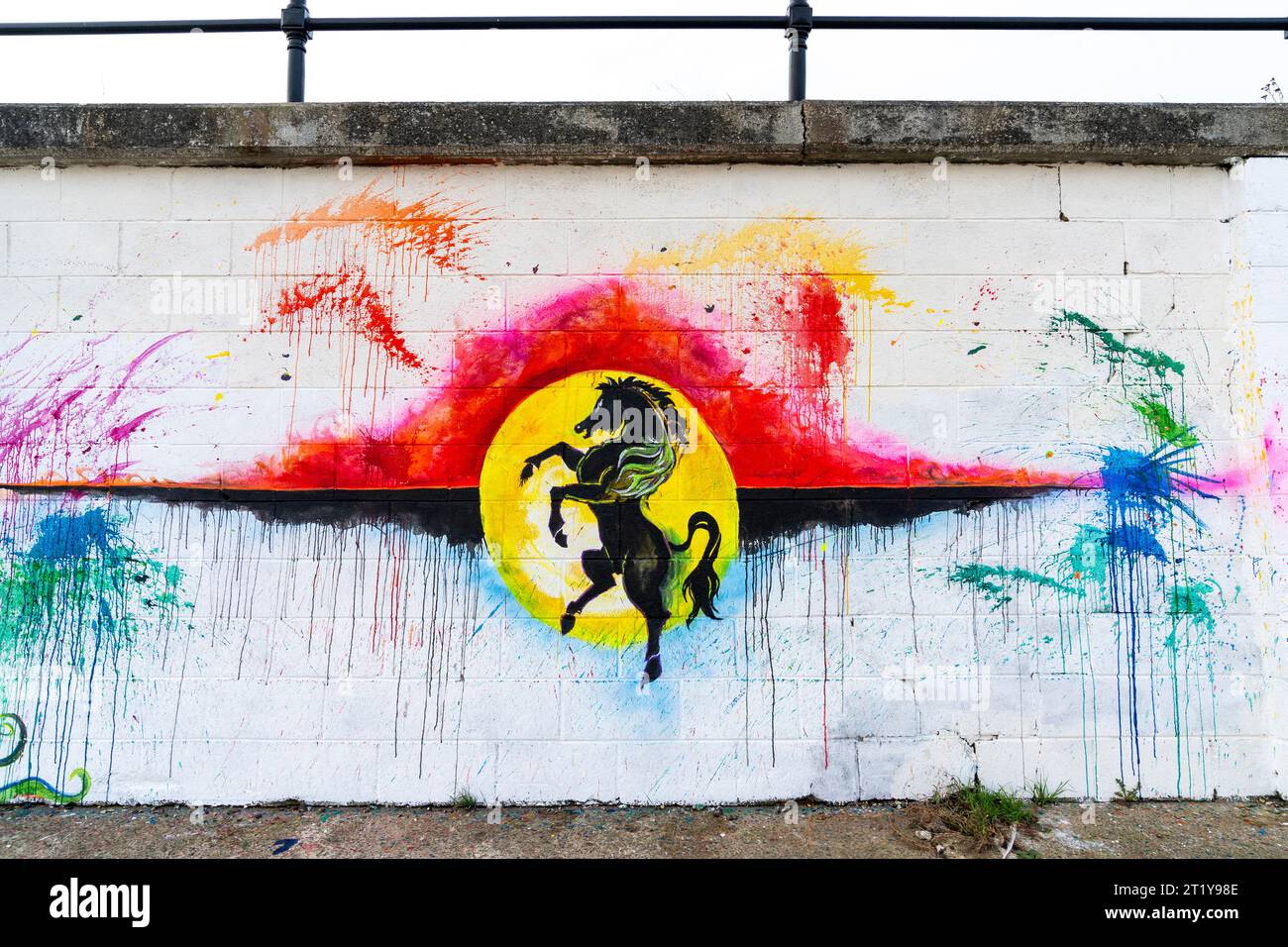 Graffiti painting of a black stallion rearing up against a yellow sun ...