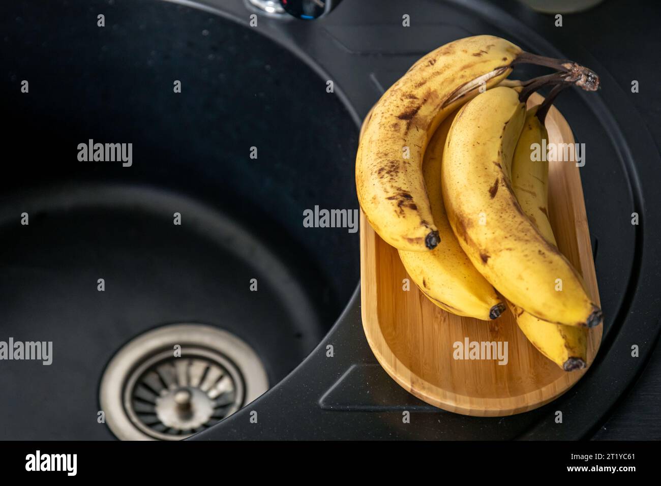 A bunch of ripe yellow bananas in the kitchen near the sink Stock Photo ...