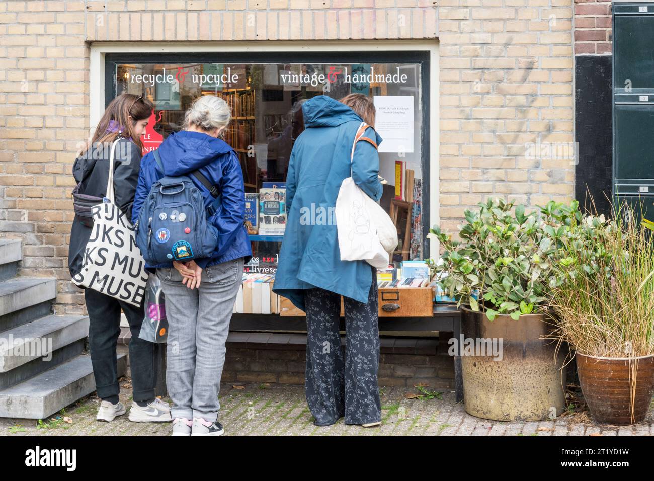 Three women looking in the window of Le Flaneur bookshop in Prinsengracht, Amsterdam Stock Photo ...