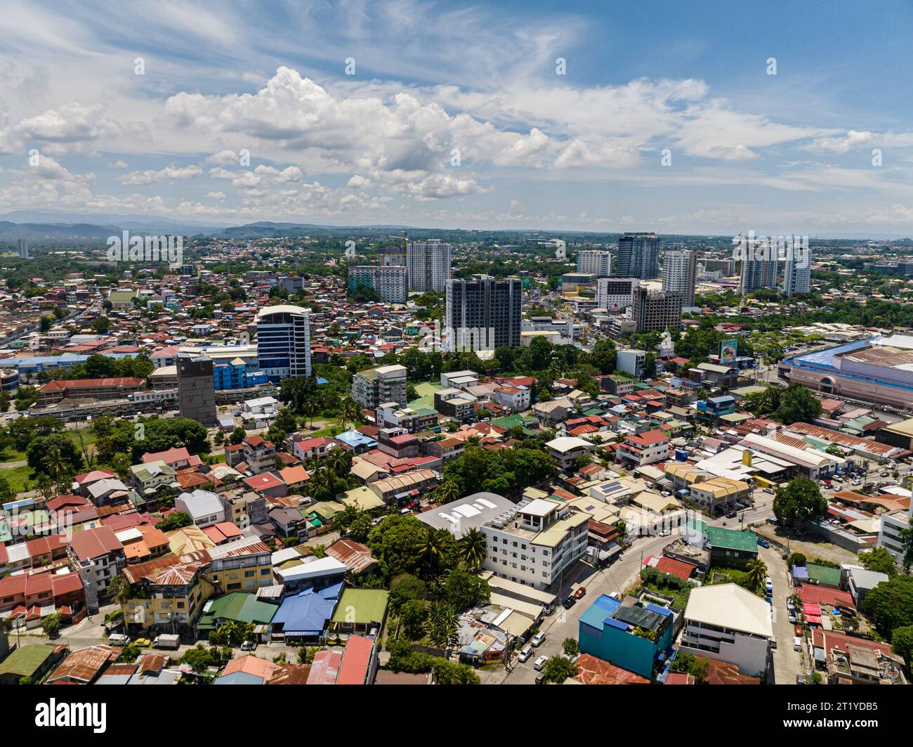 Beautiful aerial view of Capital City of Mindanao under the clouds and blue sky. Davao City ...