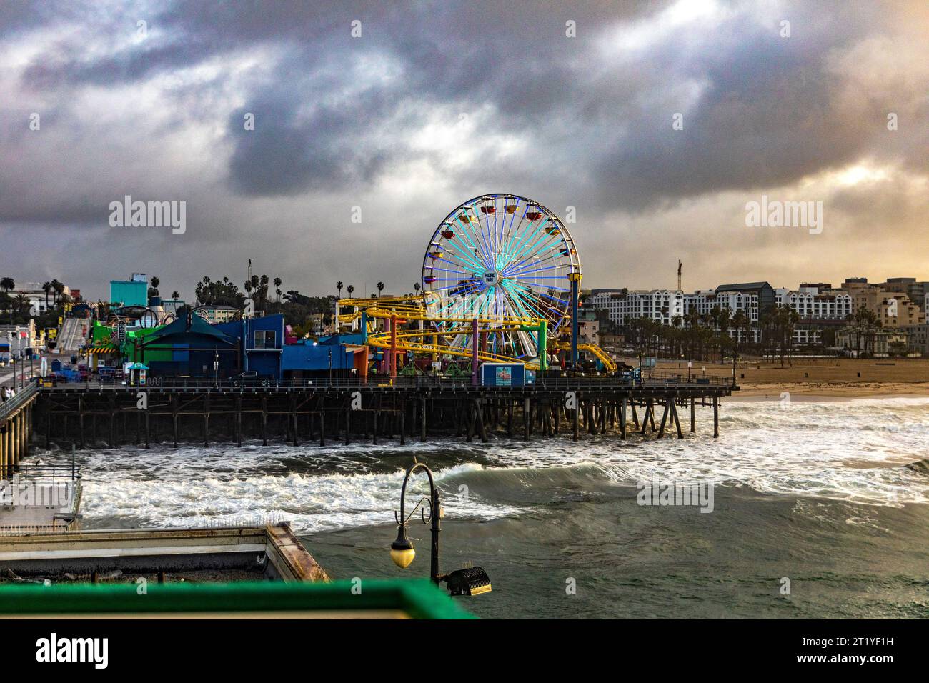 The famous Ferris wheel on the beach and Santa Monica pier under a ...