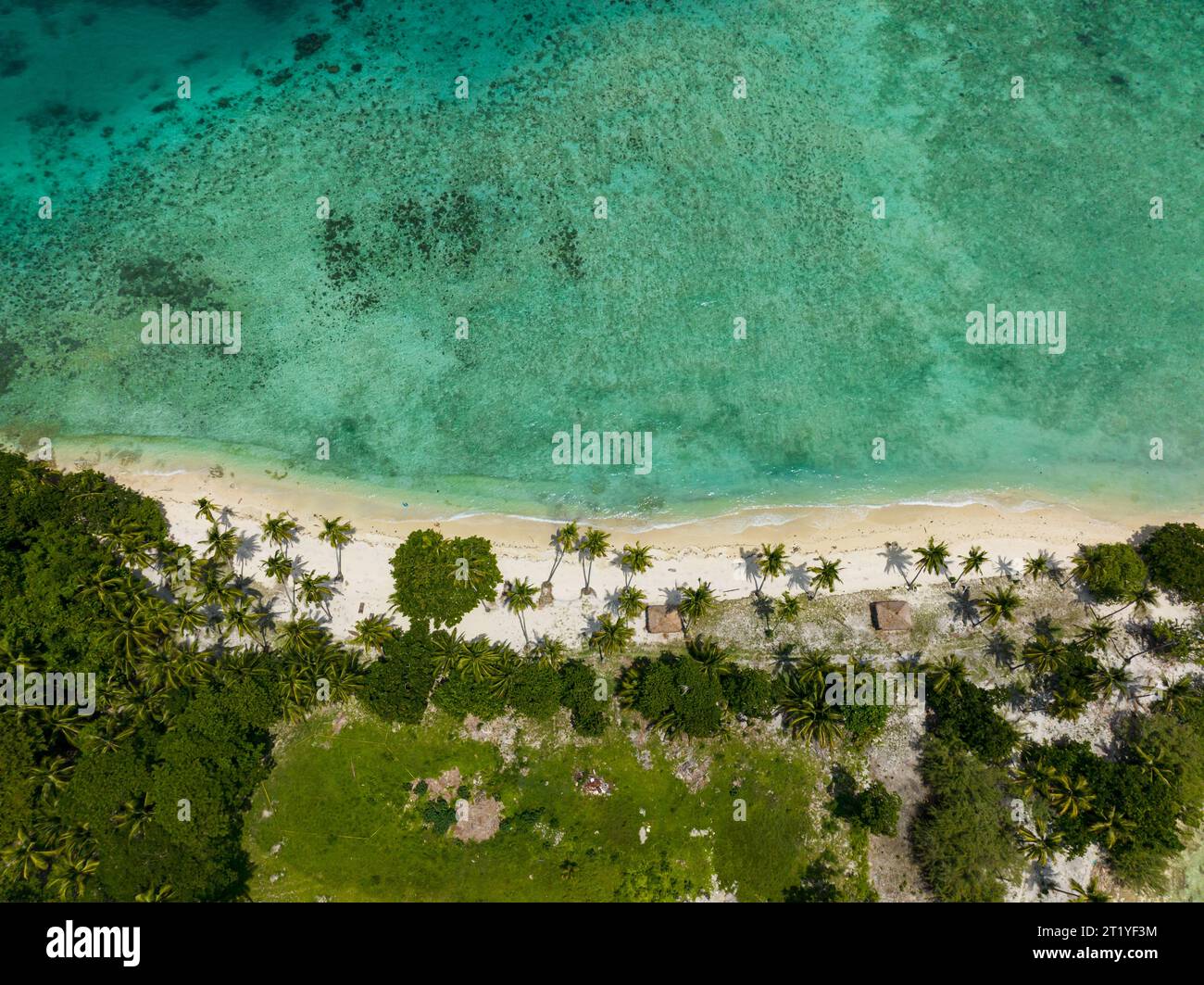 Coastline with white sandy beach and ocean waves. Malipano Island ...