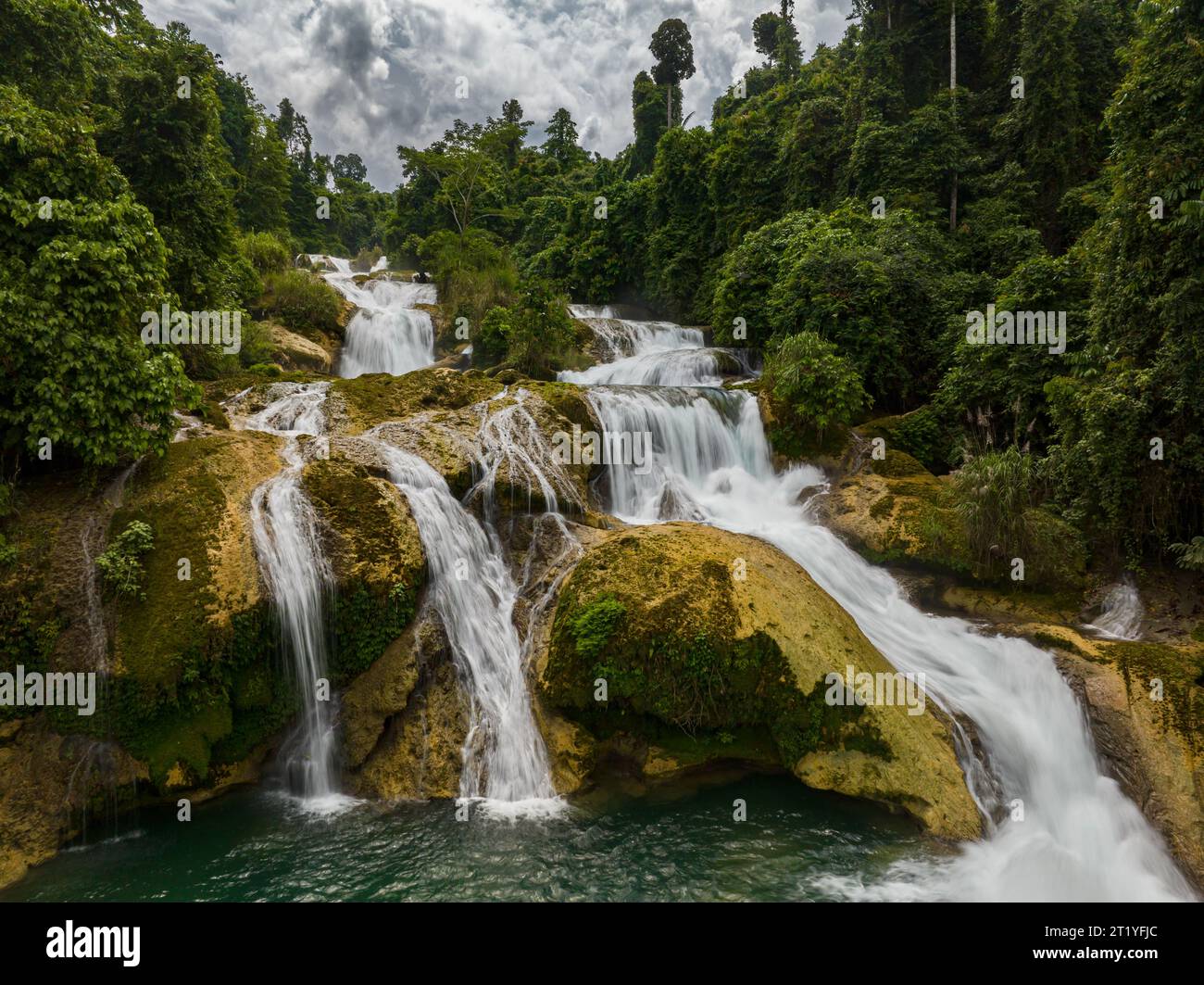 A multi-tiered waterfall with rocks. Aliwagwag Falls. Mindanao ...