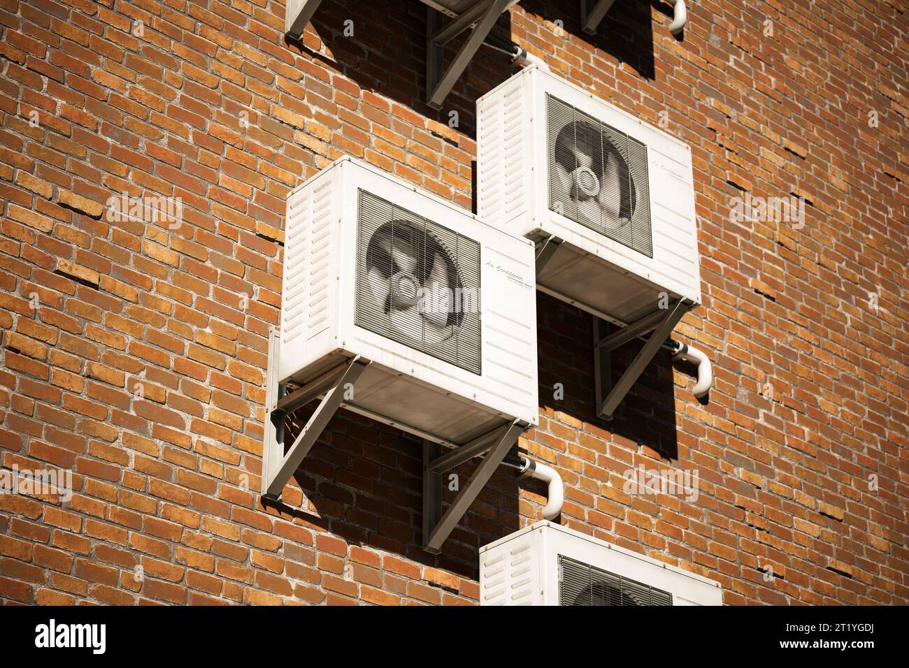 Outdoor air conditioner units on the brick wall. The ventilation ...