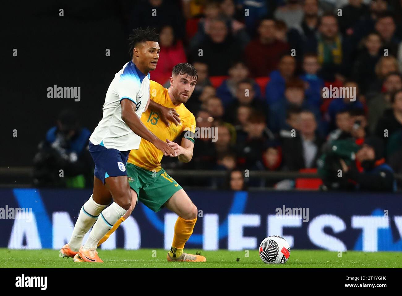 Ollie Watkins of England and Ryan Strain of Australia - England v ...