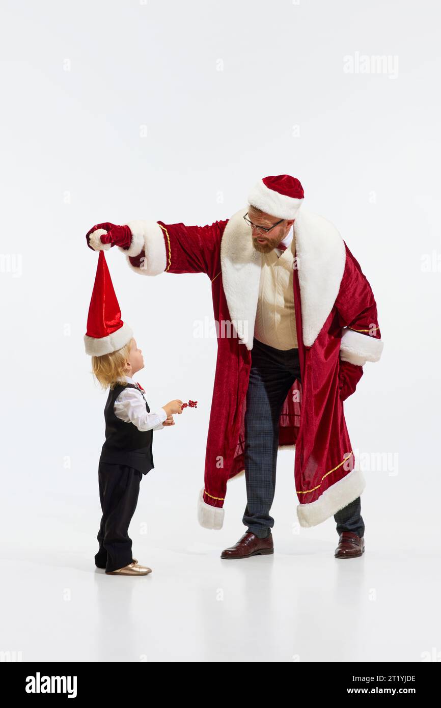 Merry Christmas. Funny father, man, dressed like Santa Claus have fun ...