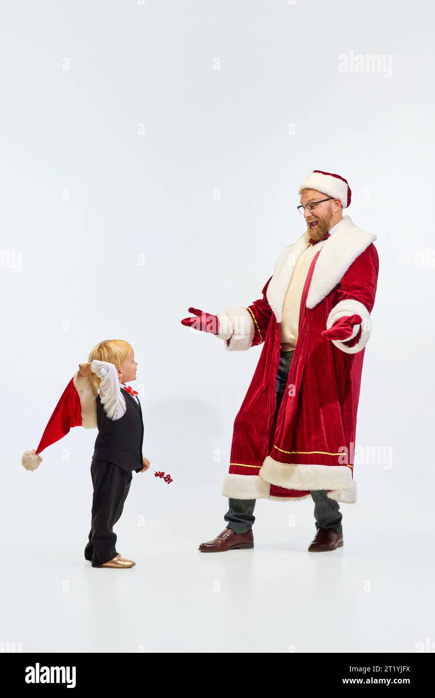 Merry Christmas. Father, man, dressed like Santa Claus having fun with ...