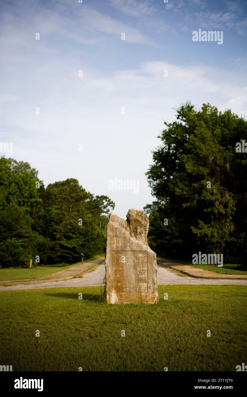 A stone in the middle of a grass field marks the first state capital of ...