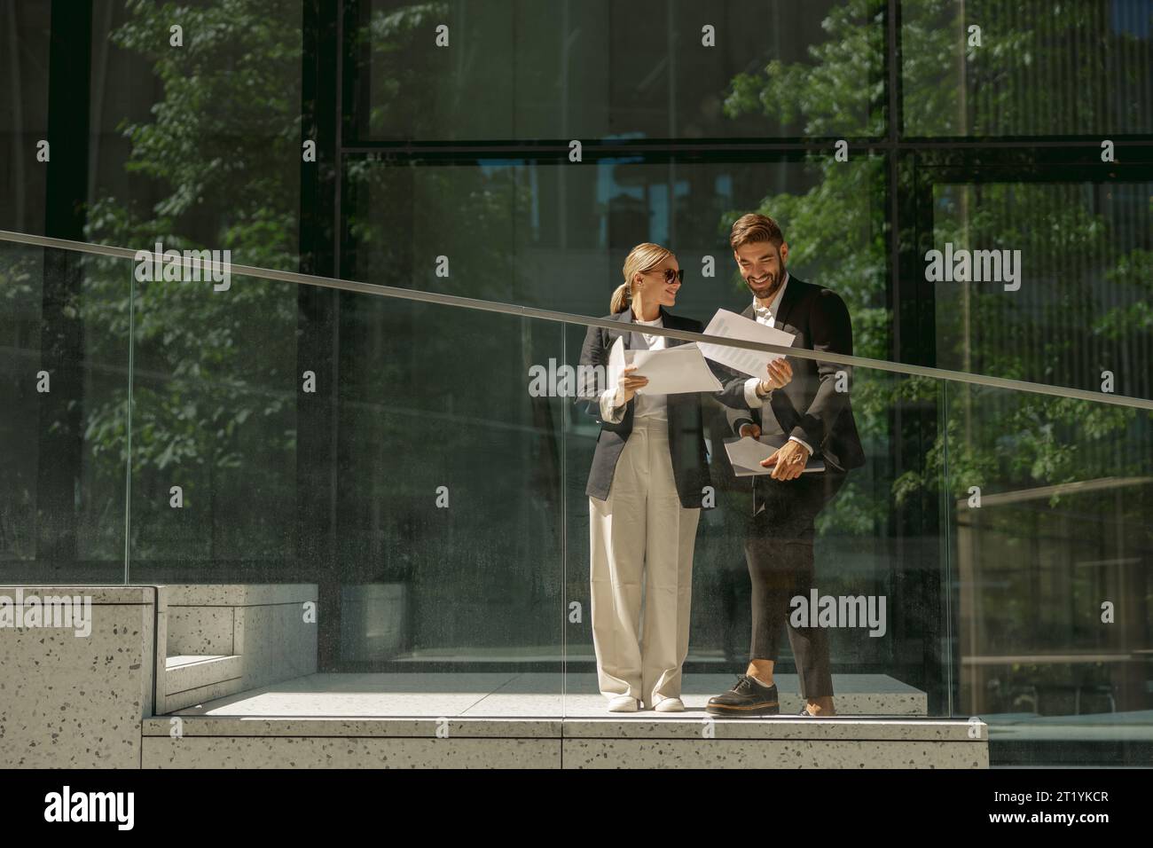 Business analysts working with documents while standing on background ...