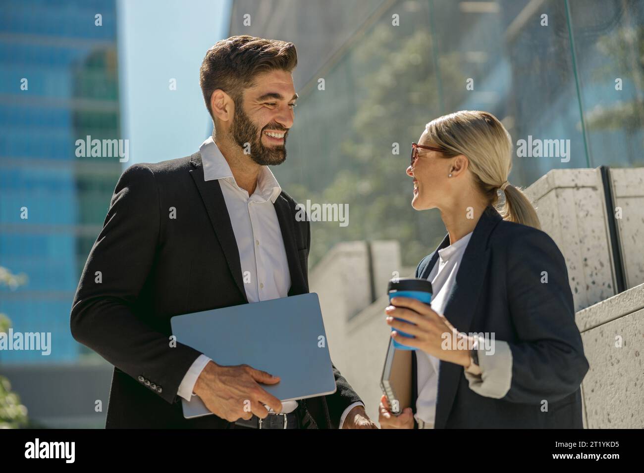 Two colleagues is talking during break time standing on background of ...