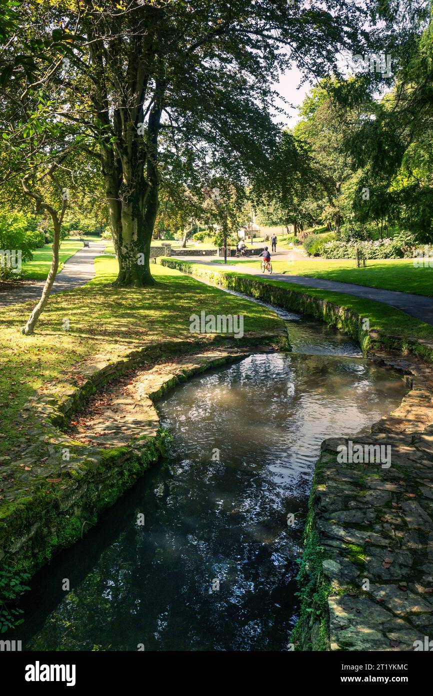 A small river stream flowing through the landscaped Trenance Gardens in ...