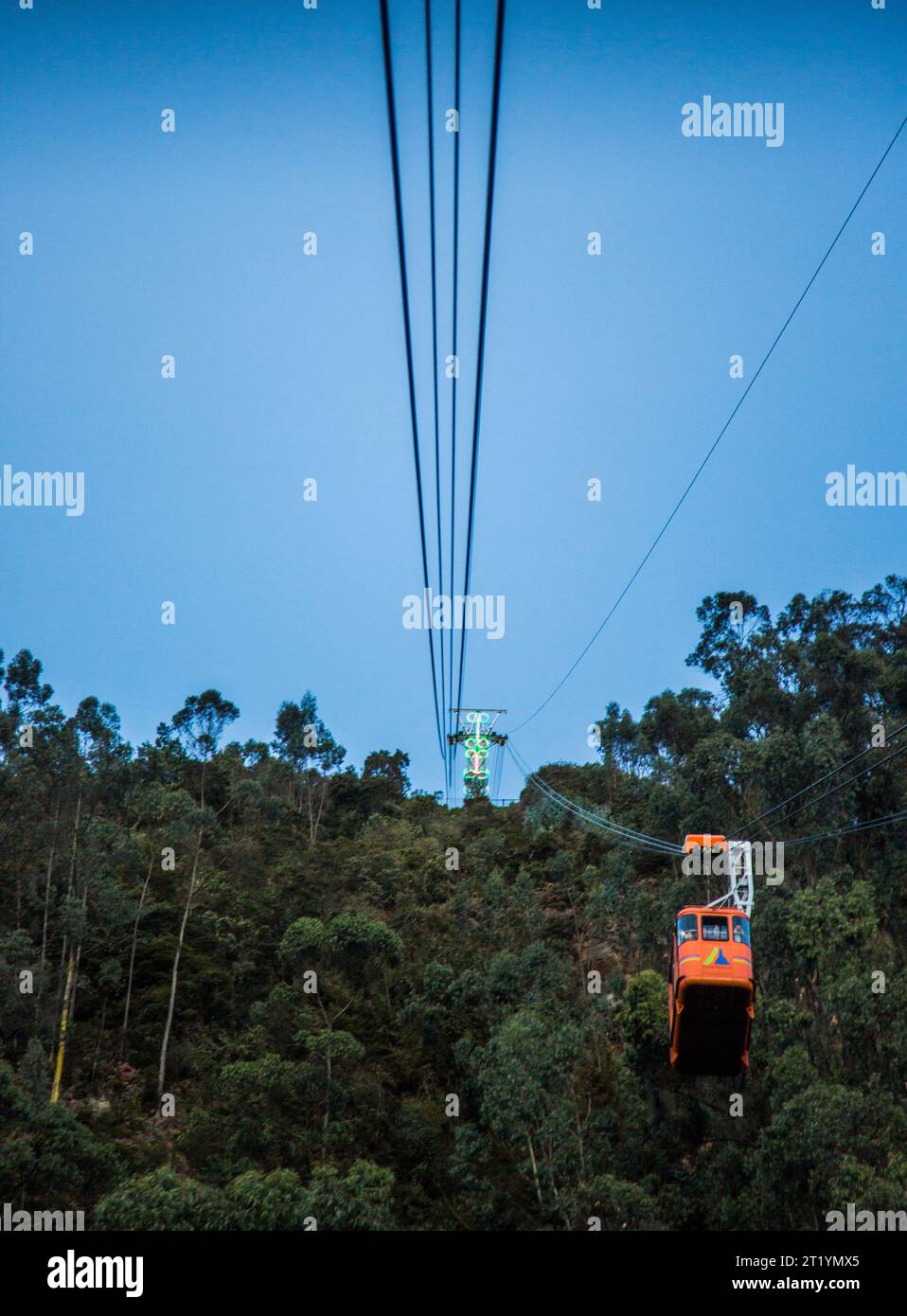 Cable cars going up to Mount Monserrate which overlooks downtown Bogota ...