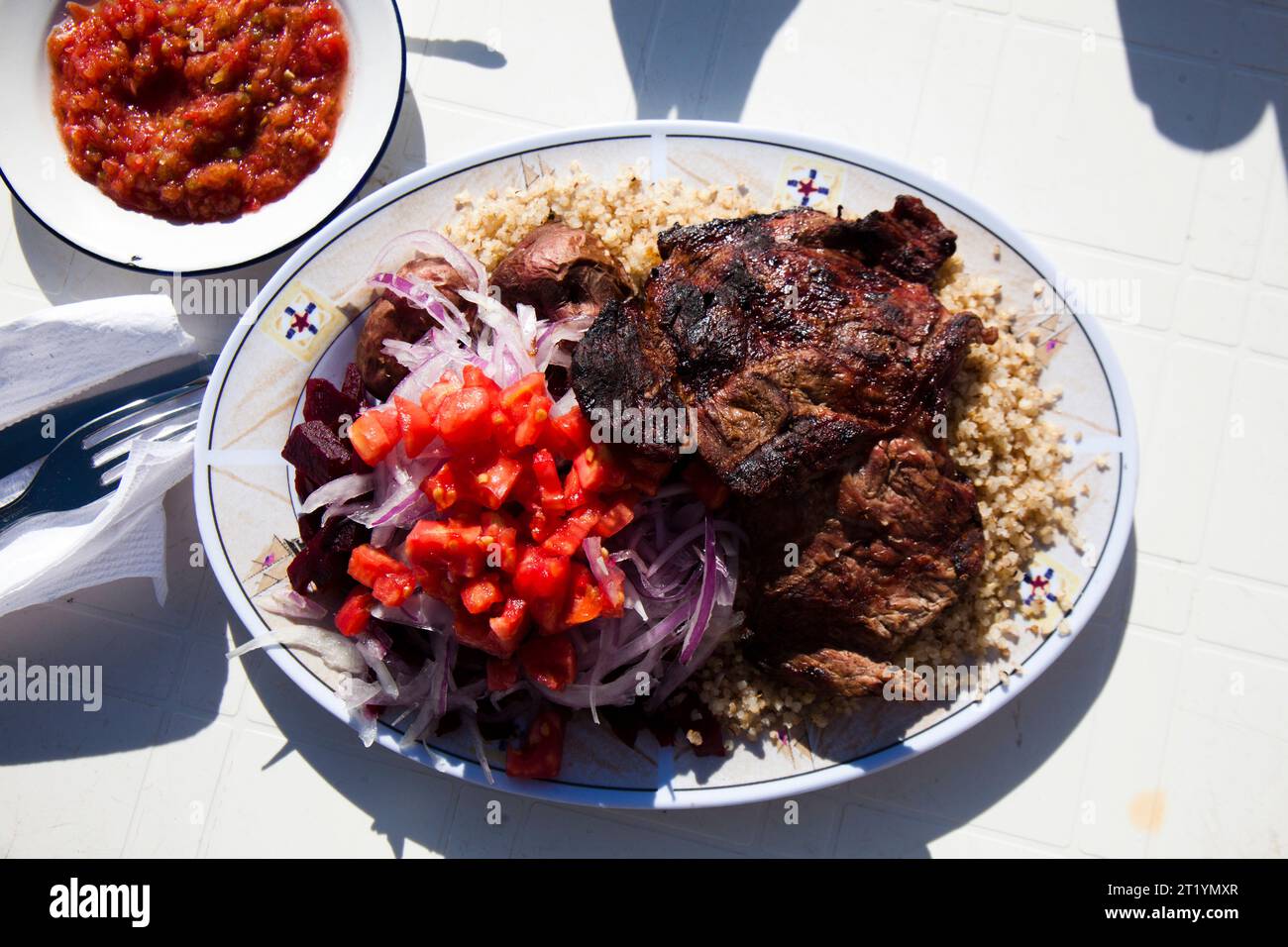 A plate of meat and vegetables at a picnic in rural Bolivia near the ...