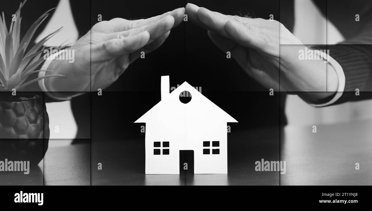 Businessman protect house by hands Black and White Stock Photos ...
