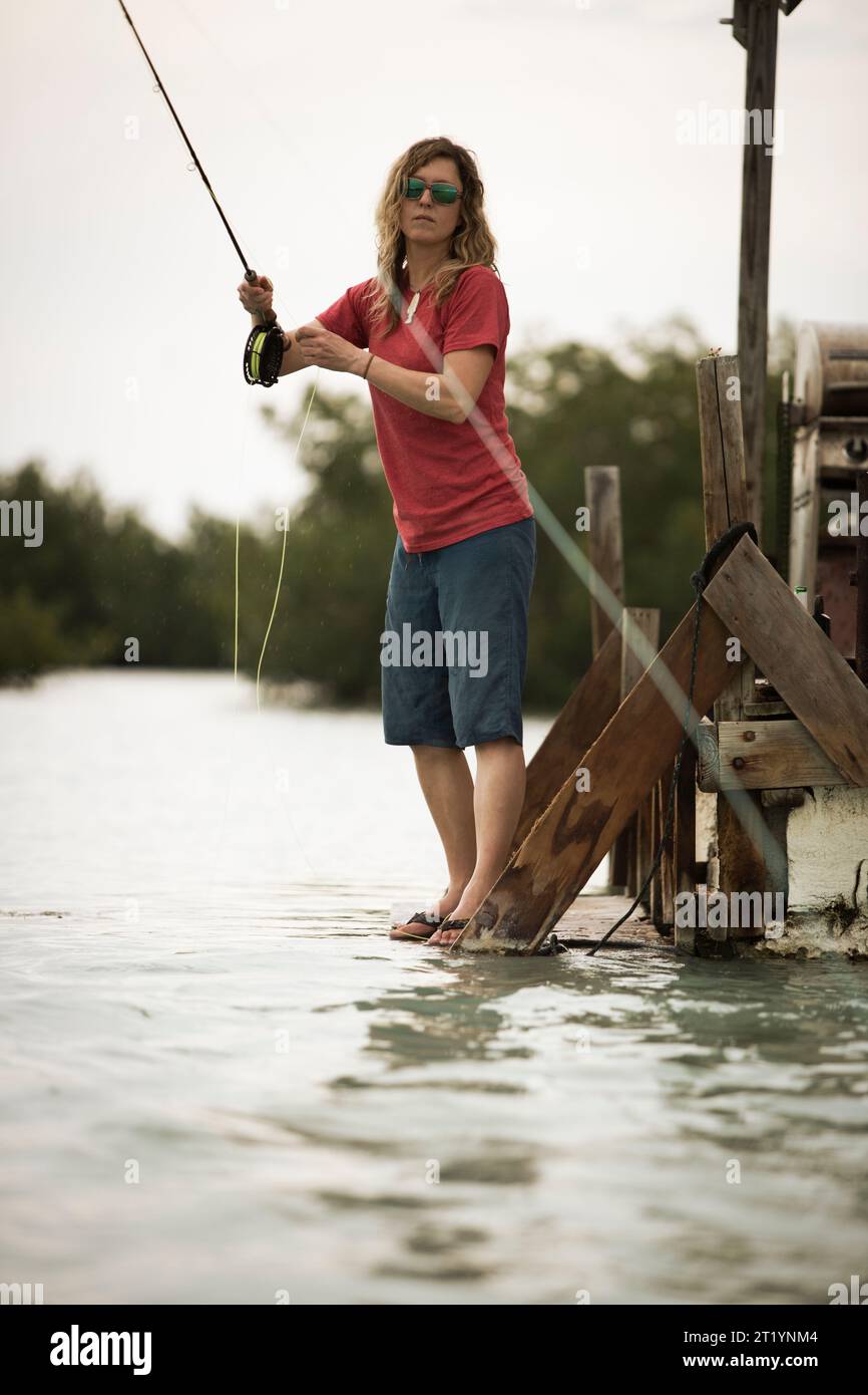 Woman fishing on rod from hi-res stock photography and images - Alamy