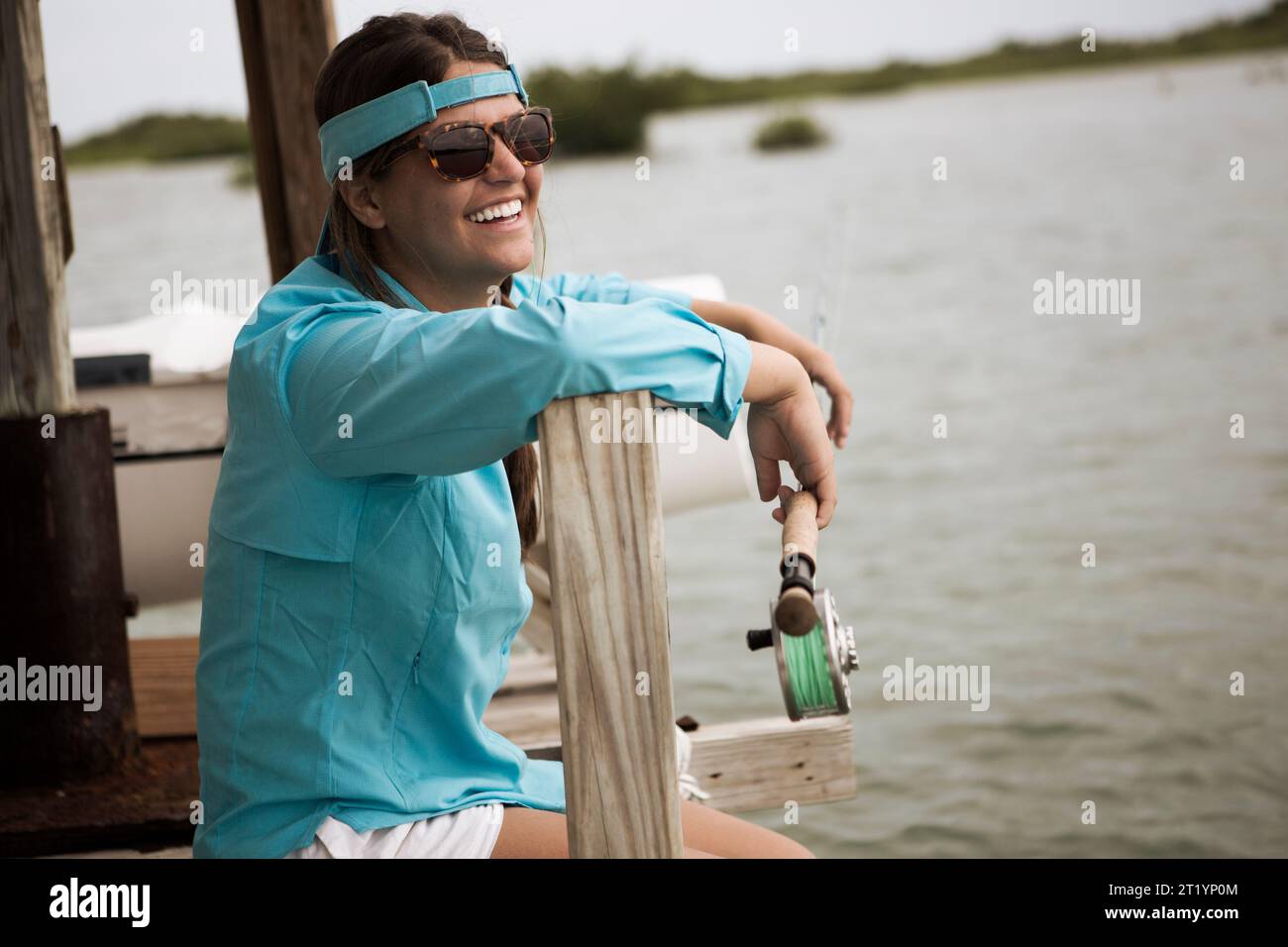 Young woman holding fishing pole hi-res stock photography and images ...