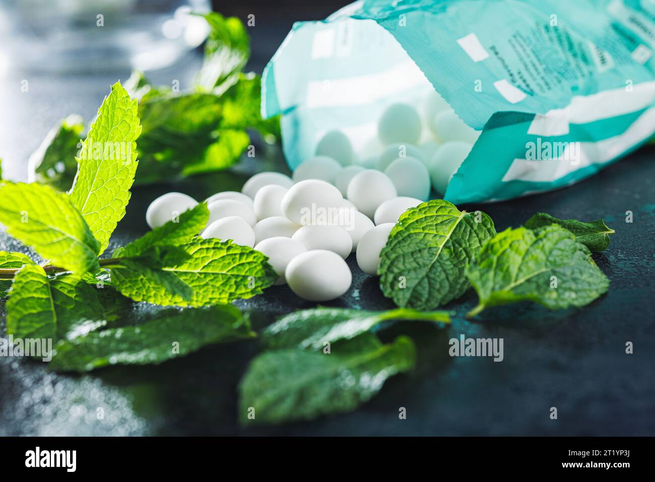 Mint candies. Menthol bonbons and mint leaves on the black table Stock ...