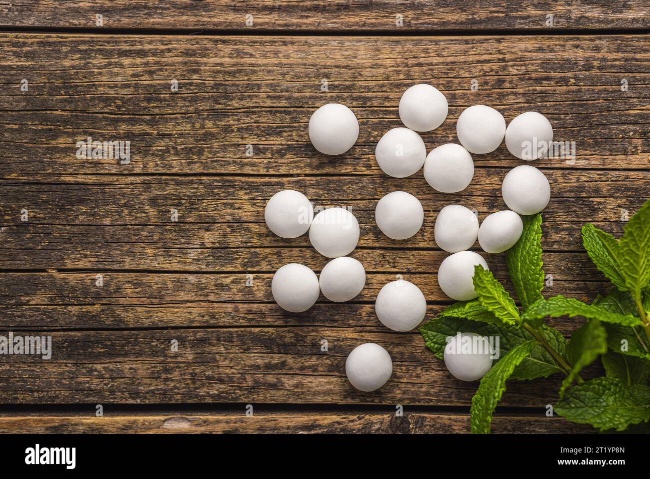 Mint candies. Menthol bonbons and mint leaves on the wooden table. Top ...