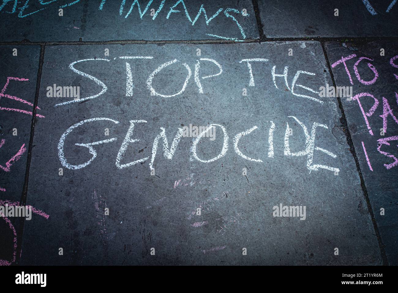 Protester paint stop the genocide with chalk on the street during the ...