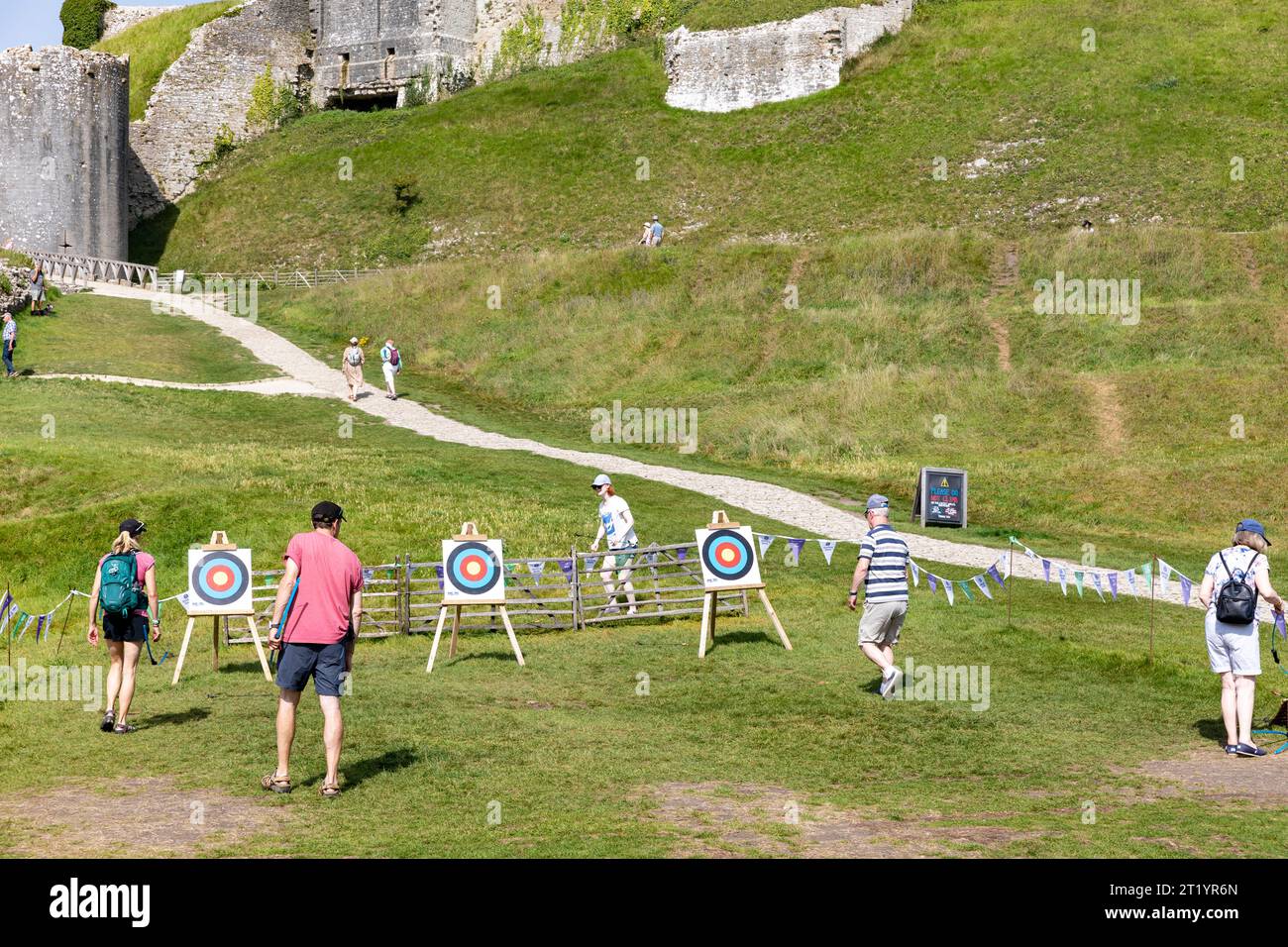 Corfe Castle Dorset, visitors use bow and arrows to practice shooting ...