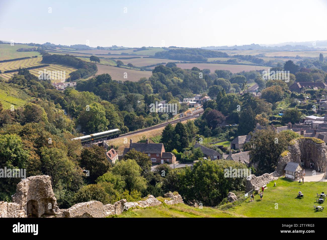 Corfe Castle aerial view of castle ruins and castle grounds on sunny ...
