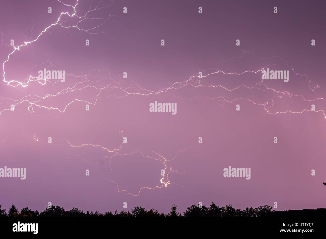 Lightning zapping from left to right across the cloud-covered gray ...