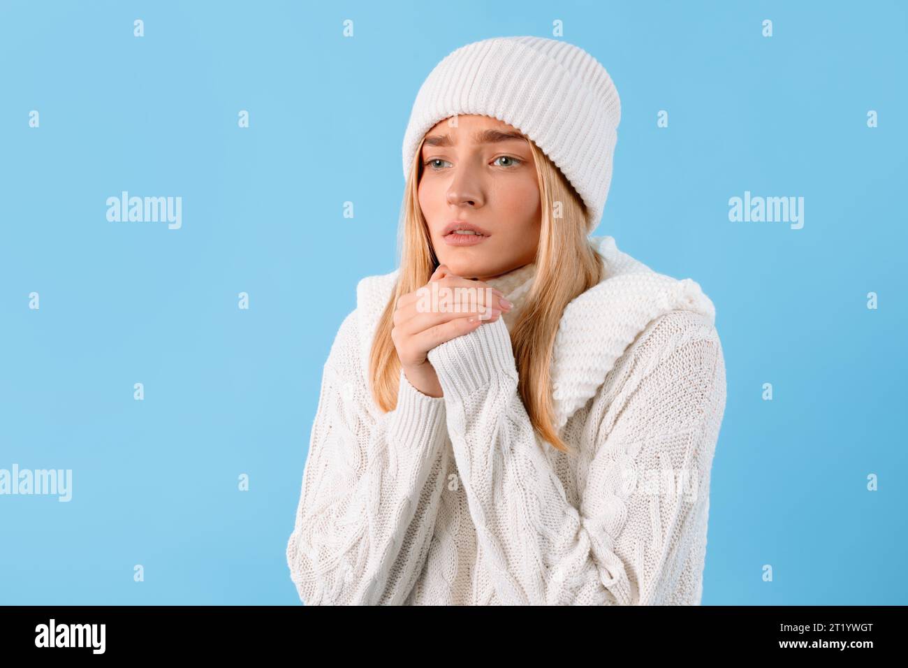 Young woman suffering from cold, freezing lady wearing knitted sweater ...