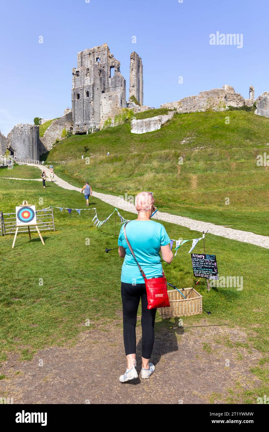 Corfe Castle Dorset, model released woman using bow and arrow at the ...