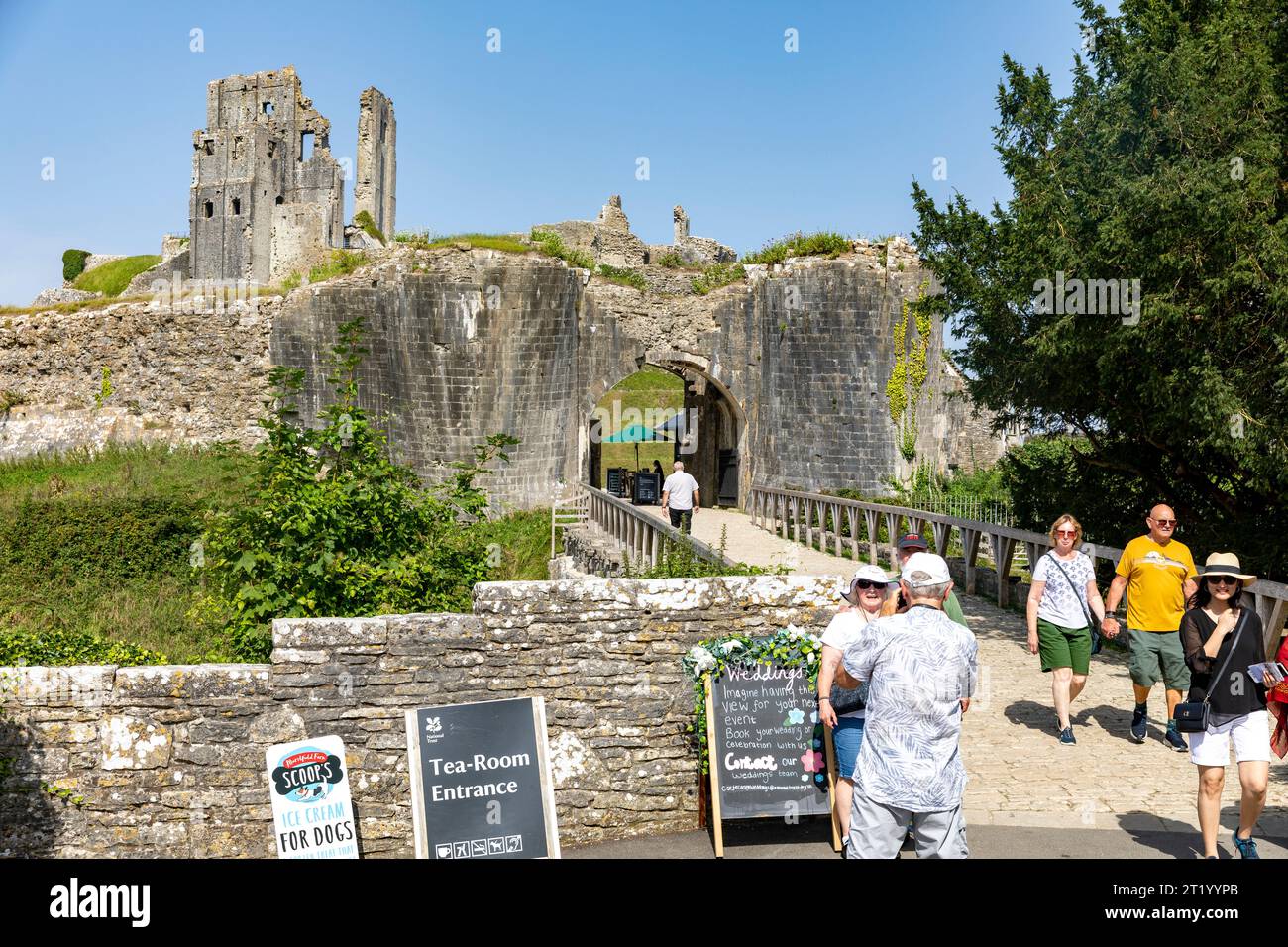 Visitors enter Corfe Castle on a blue sky sunny autumn day, Isle of ...