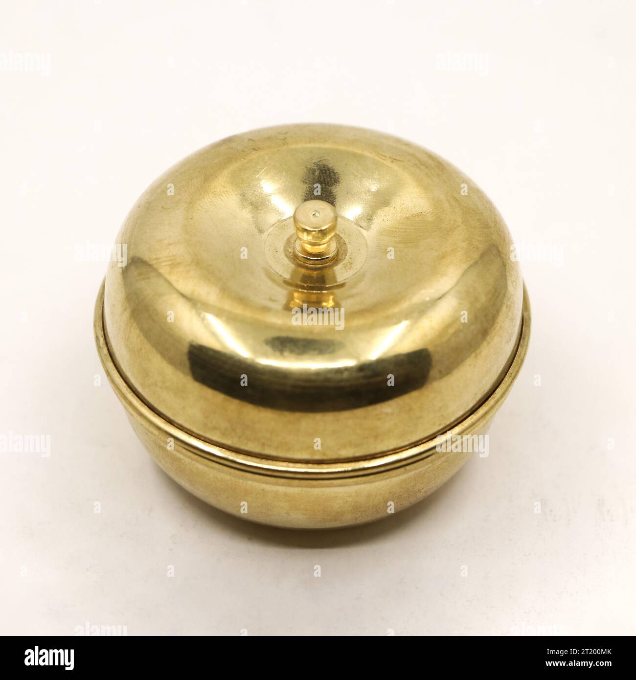 a traditional golden brass box bowl with lid used to store food spice ...