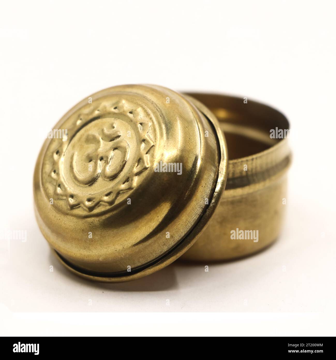 closeup of a golden bronze box jar with hindu om symbol inscribed on ...