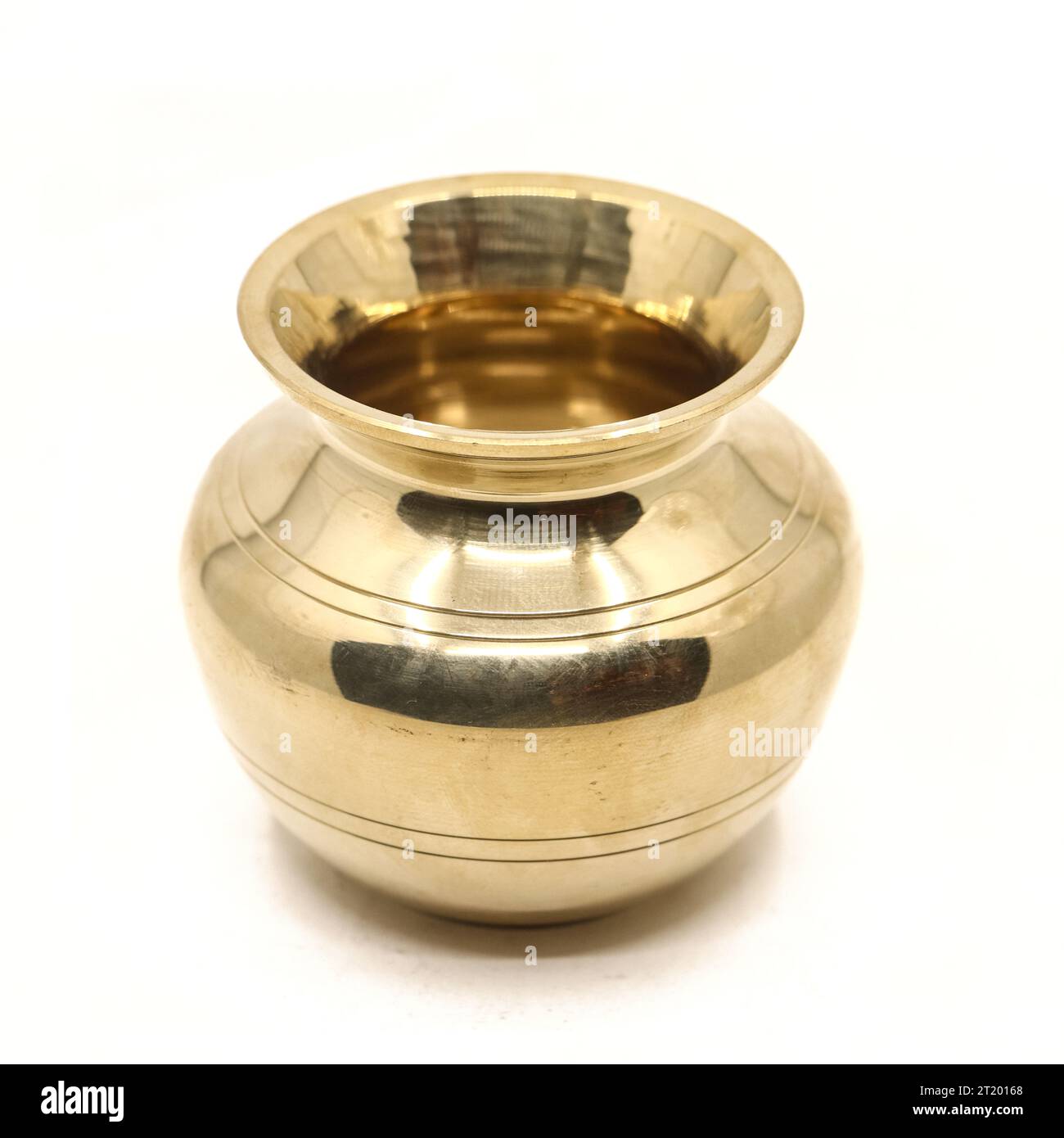 a clean golden indian brass vessel used as a water pot for traditional ...