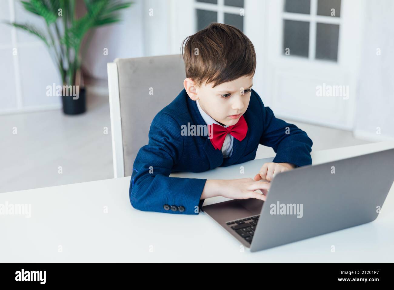 Happy pupils using laptop class hi-res stock photography and images - Alamy