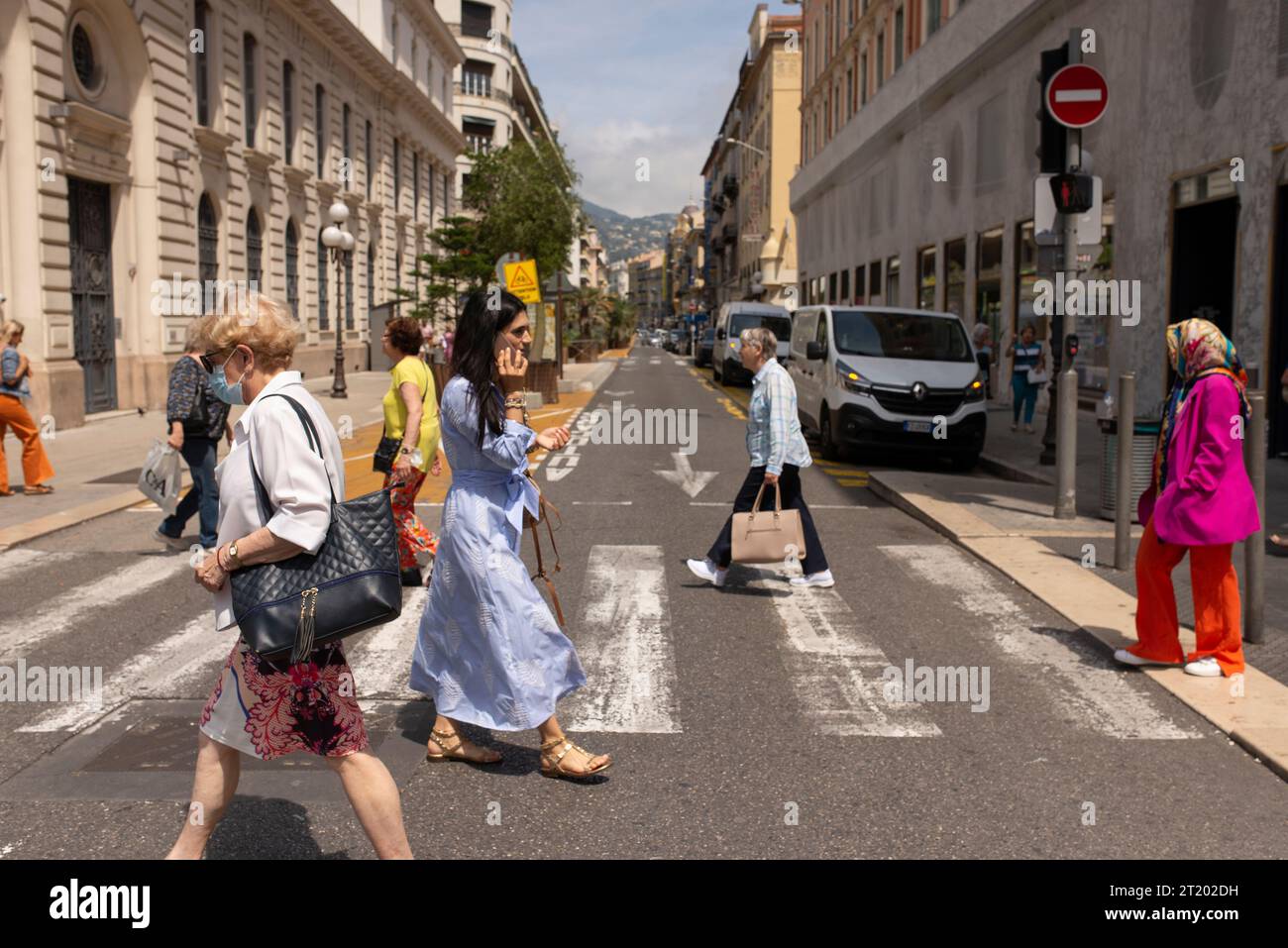 Selection of people walking across road on crossing Stock Photo - Alamy
