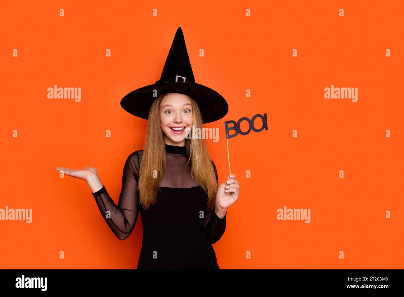 Photo of attractive blonde teen woman hold palm empty space boo sign ...