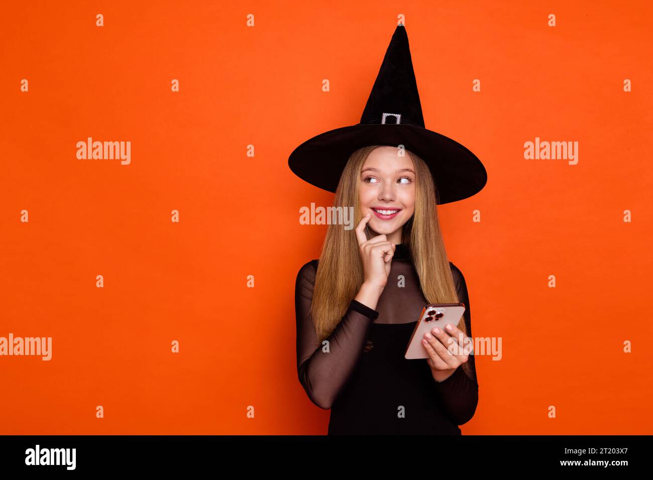 Photo of tricky cunning lady wear black wizard costume cap typing ...