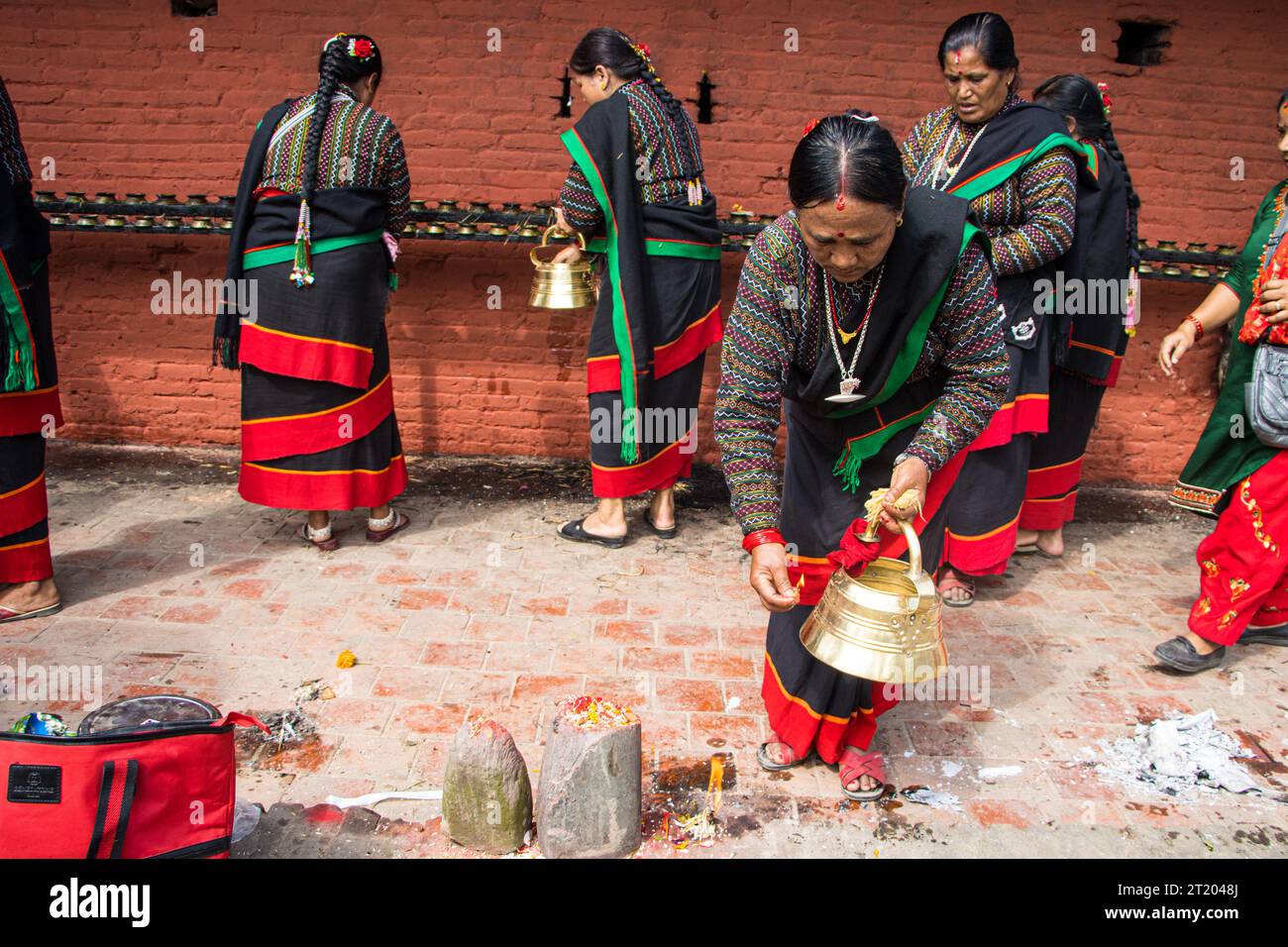 Newar women of Khokana wearing Haku Patasi Sari make offerings to the ...