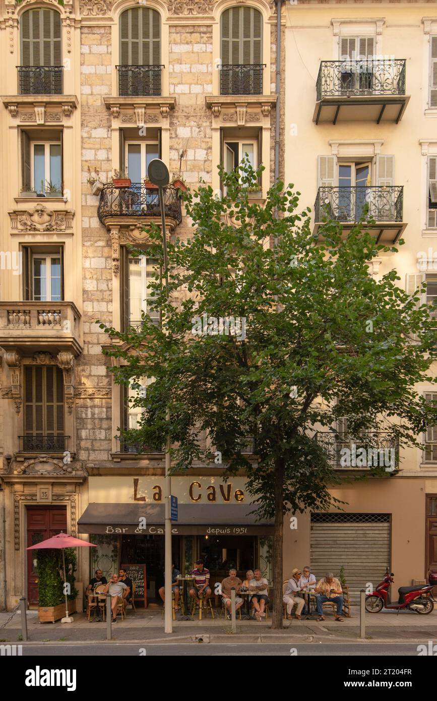 Footpath cafe under apartments Stock Photo - Alamy