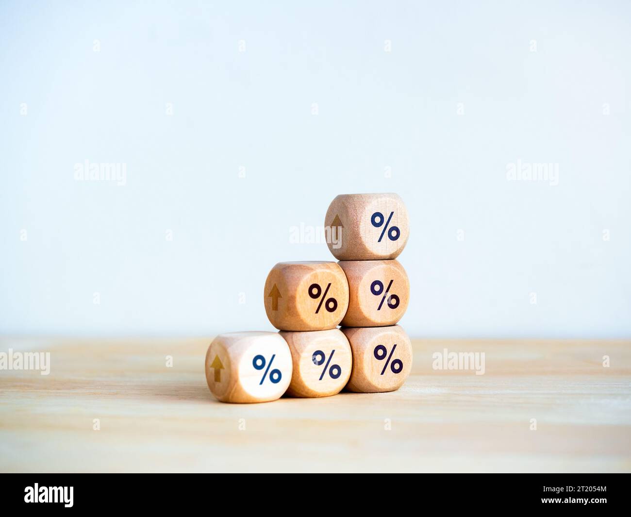 Percentage icon and up arrow on wooden cube blocks build as business ...