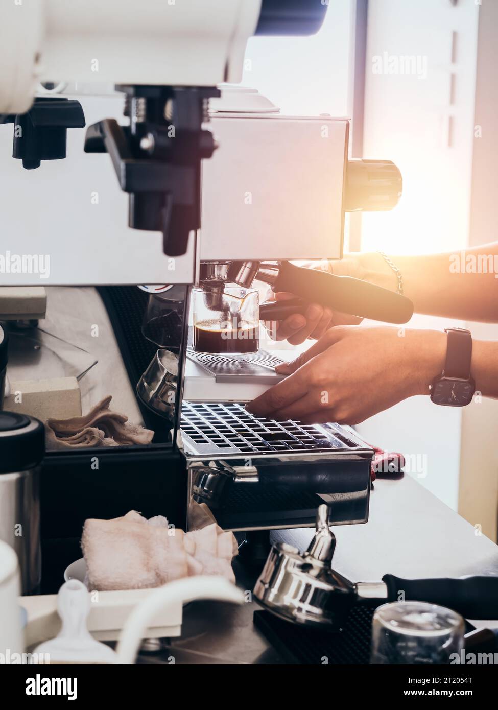 Coffee measure pitcher in barista hands who making with espresso ...
