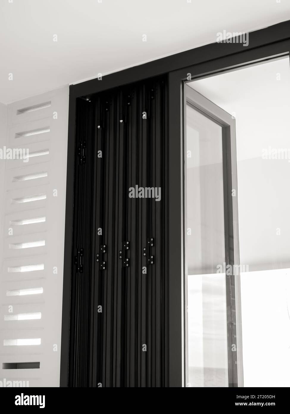 Close-up door hinges on the black aluminum folding doors with glass on ...
