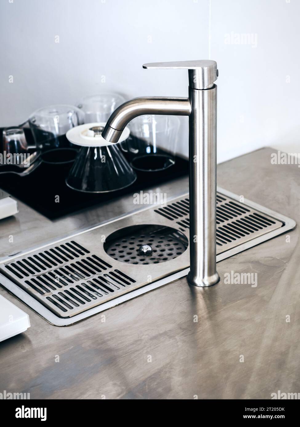 Close-up bright modern aluminium faucet at the barista counter bar in ...