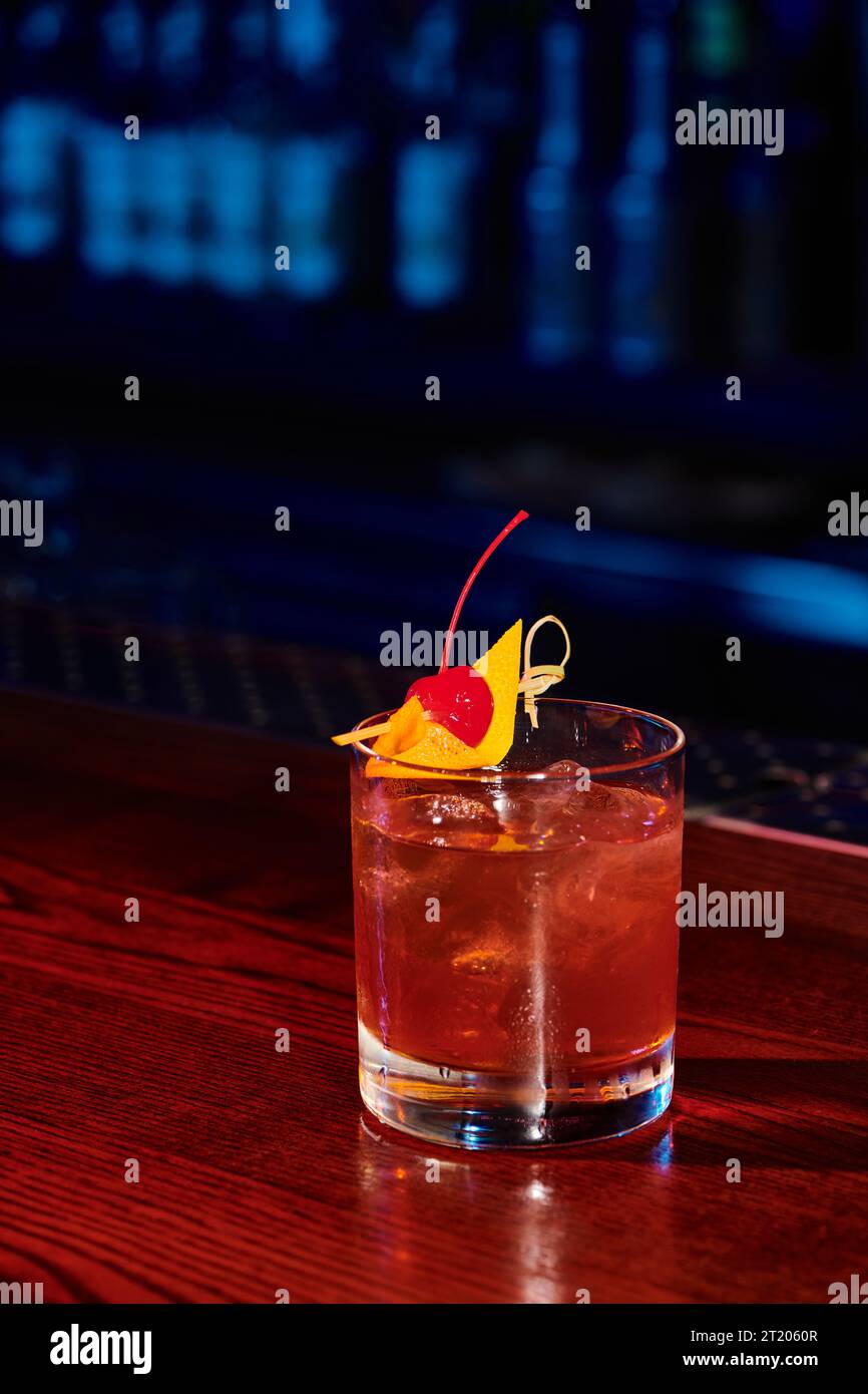 esthetic thirst quenching glass of negroni with cherry with bar on ...