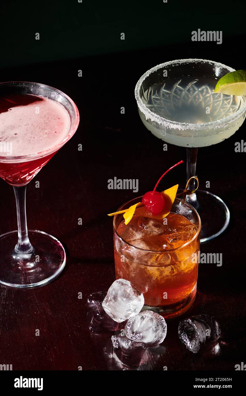 freshening margarita, cosmopolitan and negroni with ice cubes on black ...